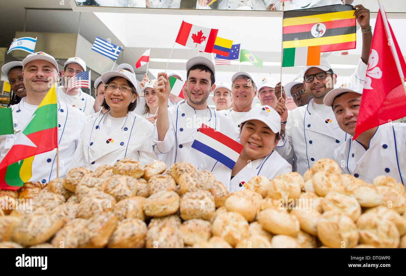 Participants in an international baking course pose with the flags of ...