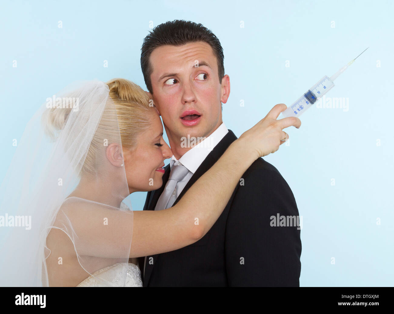 Groom looking puzzled over his shoulder at a syringe in the hand of his ...
