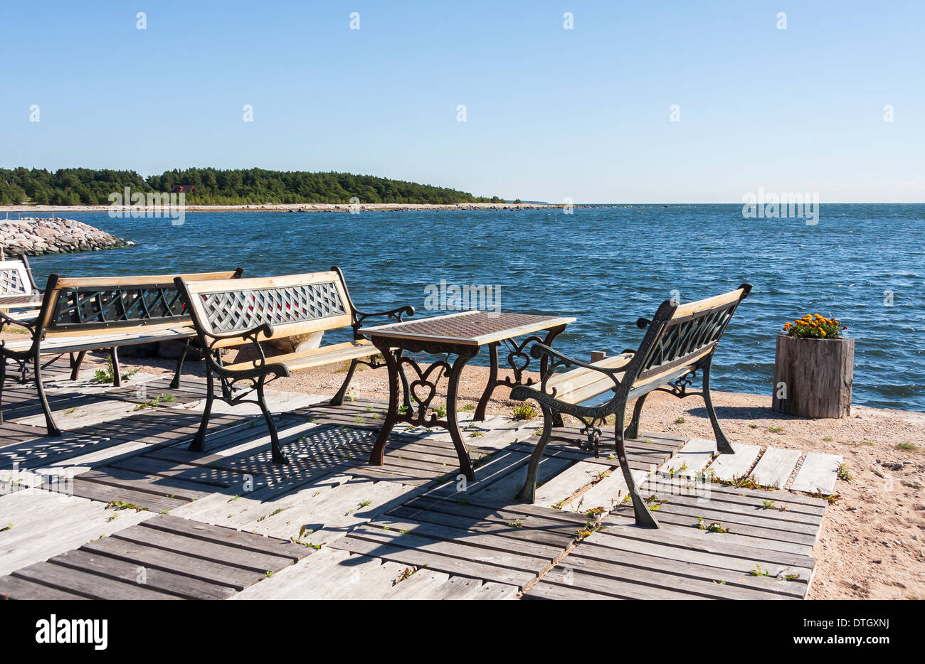 Large seats and table near sea at summer Stock Photo - Alamy