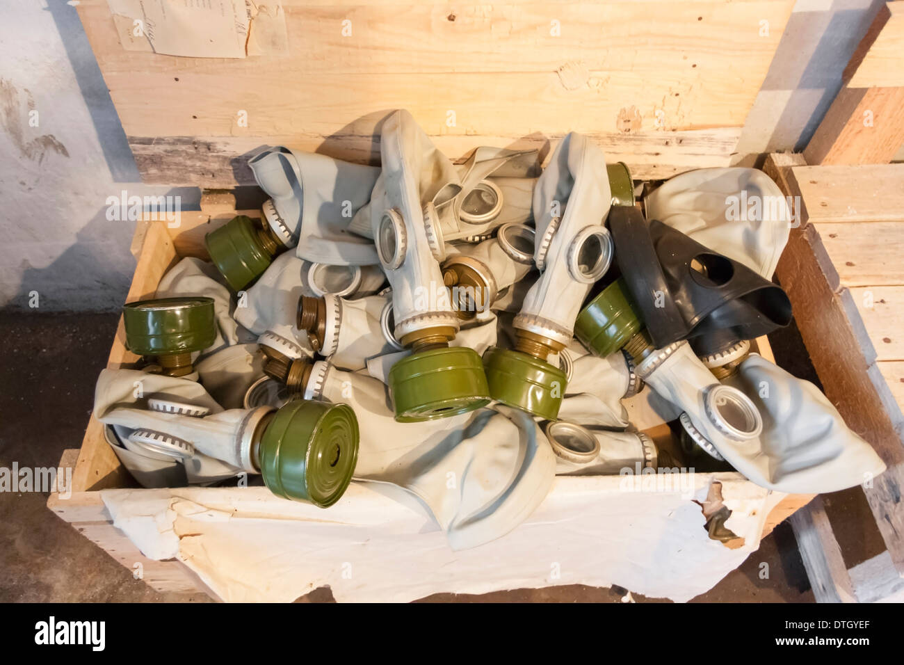 Many gas masks with green balloon in a chest Stock Photo - Alamy