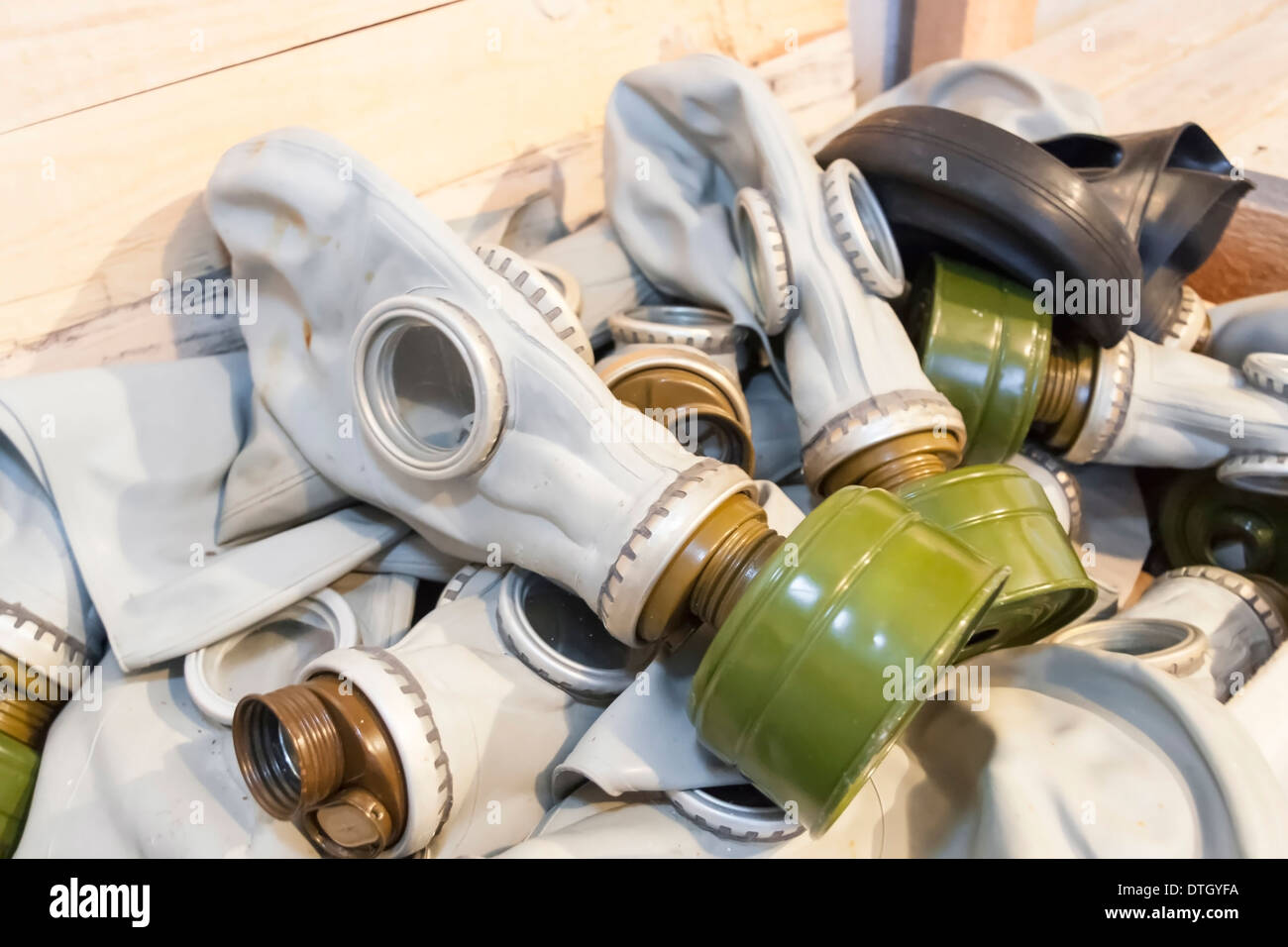 Many gas masks with green balloon in a chest Stock Photo - Alamy