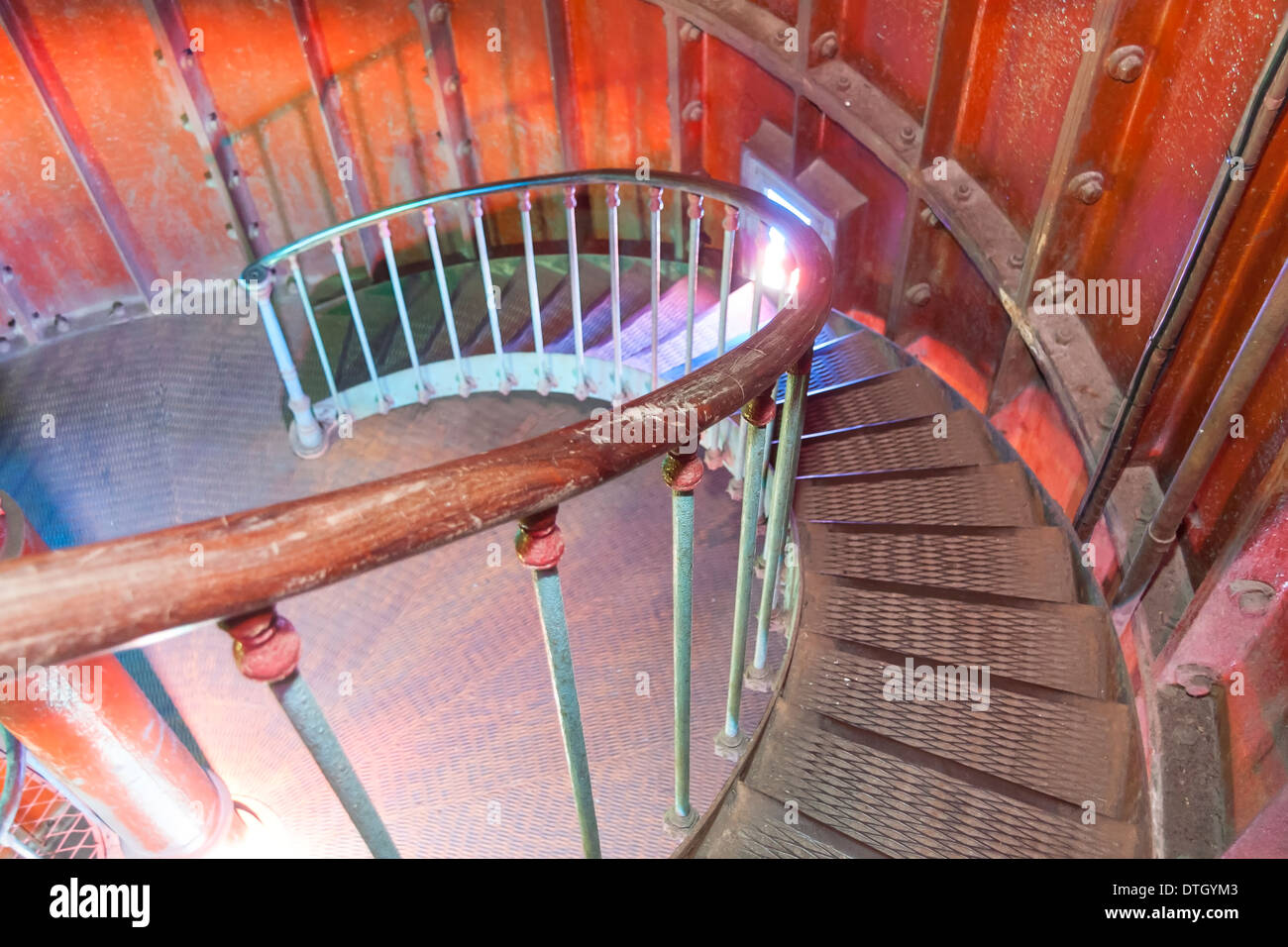 Metal screw stair inside red room Stock Photo - Alamy