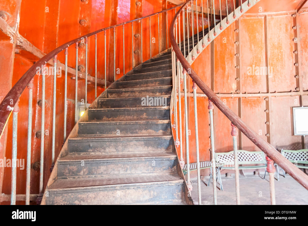 Metal screw stair inside red room Stock Photo - Alamy