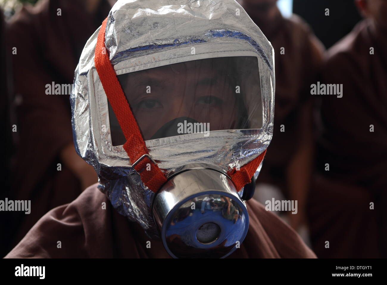Bangkok, Thailand. 18 February 2014. Thai monk wears a protective mask ...