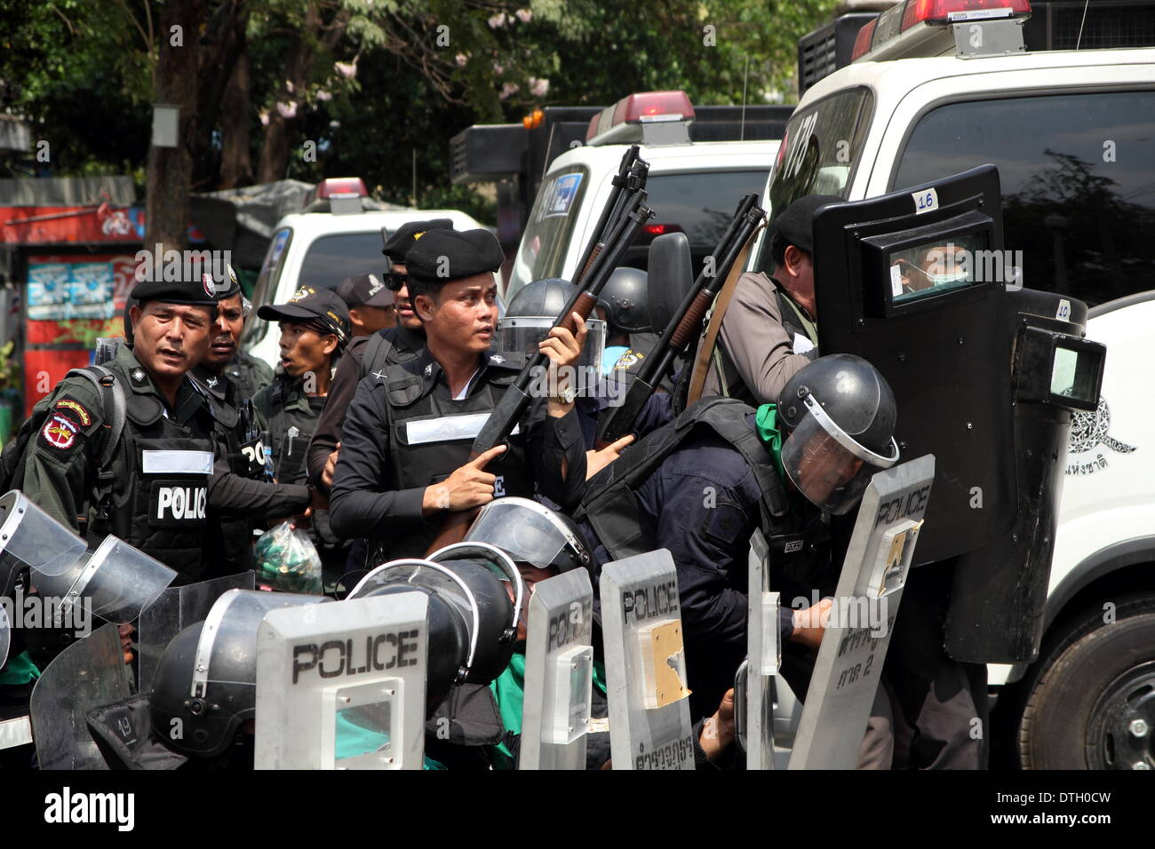 Bangkok, Thailand. 18 February 2014. Thai riot police officers shield ...