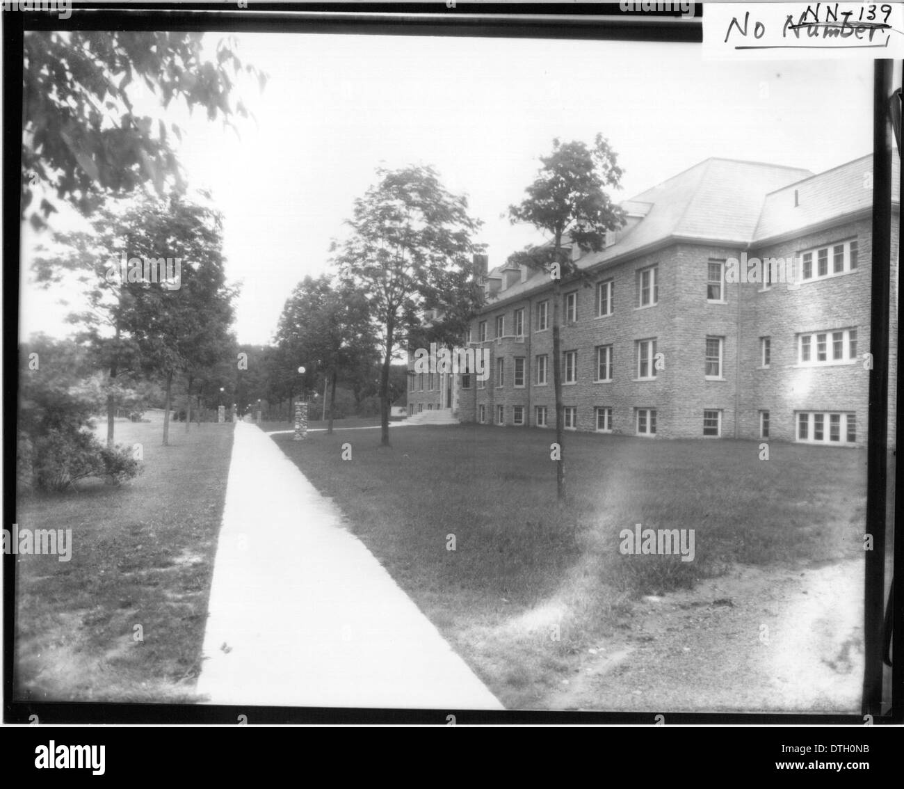 This historic photograph showcases a building along the campus walk at ...