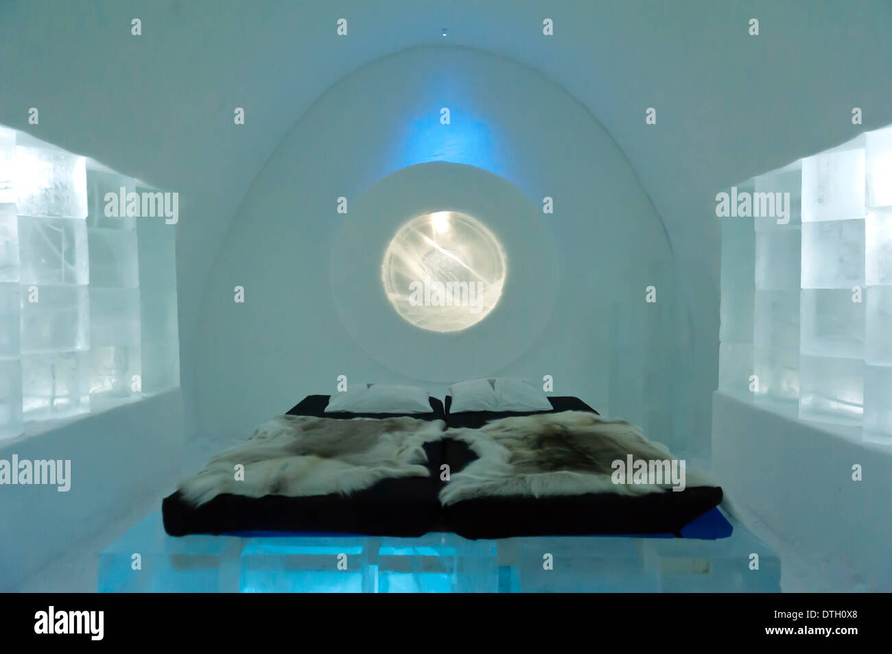Artfully decorated room made of ice, double bed with reindeer fur ...