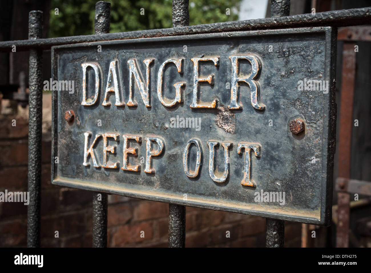Rusty old danger keep out sign Stock Photo - Alamy