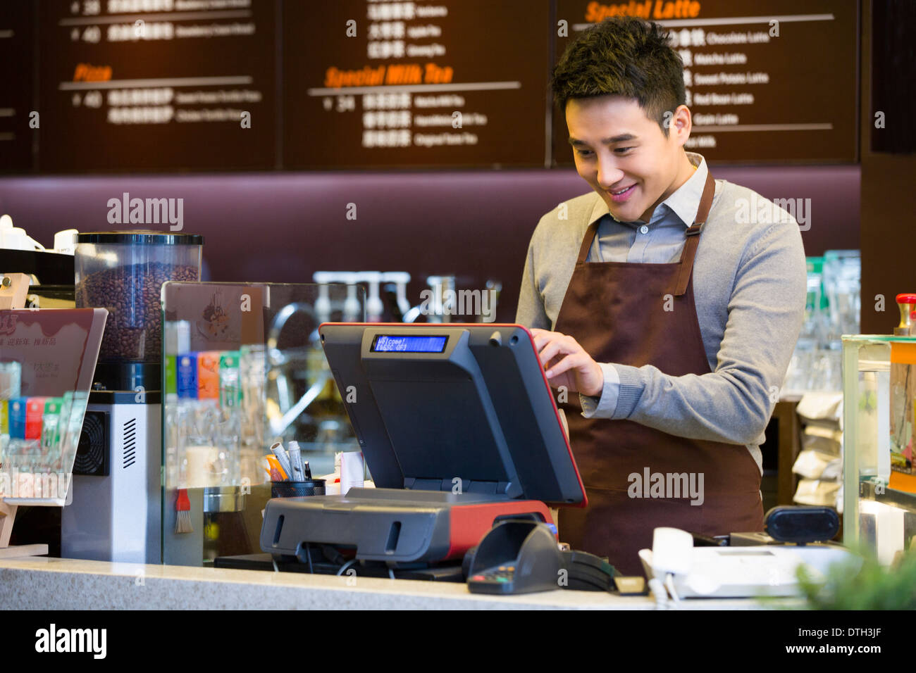 Male coffee store clerk working Stock Photo - Alamy