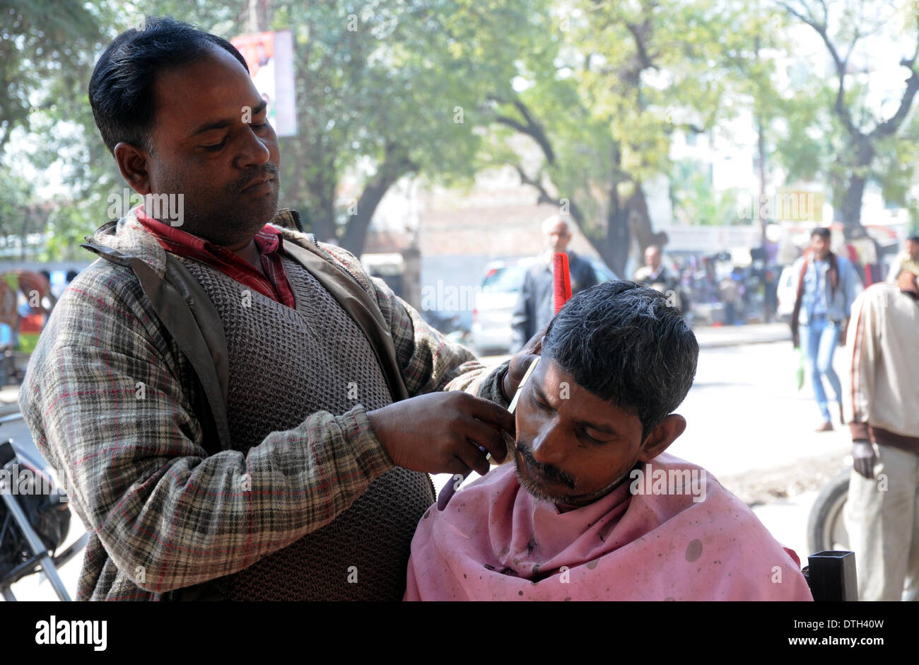 Indian barber cutting hair in street hi-res stock photography and ...