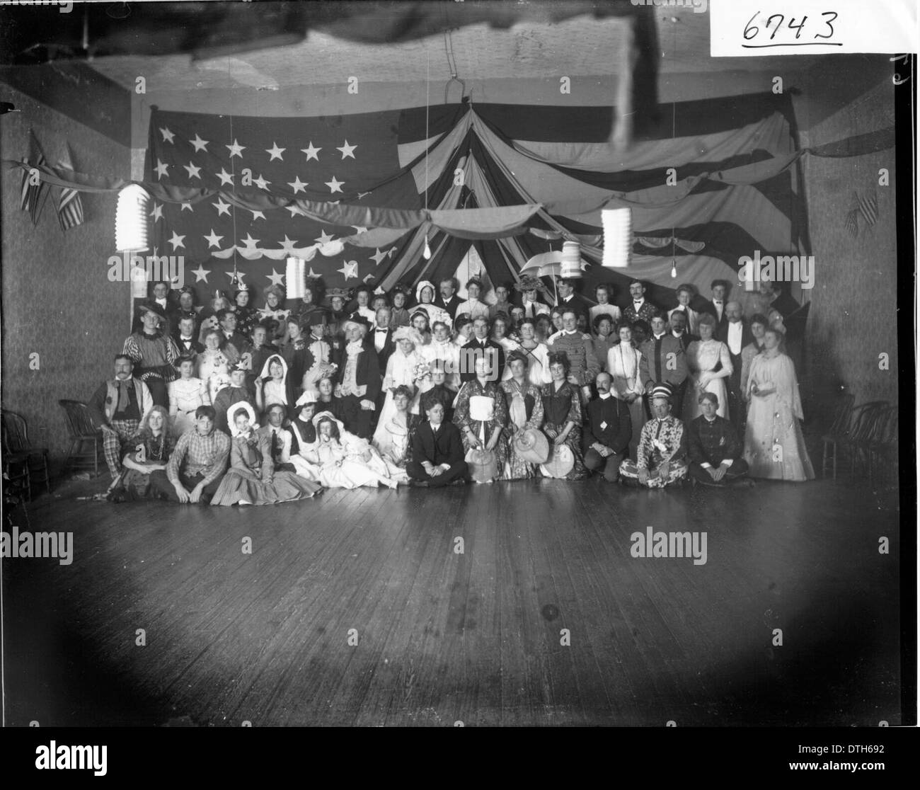 The photograph from 1902 captures participants in a costumed dance ...