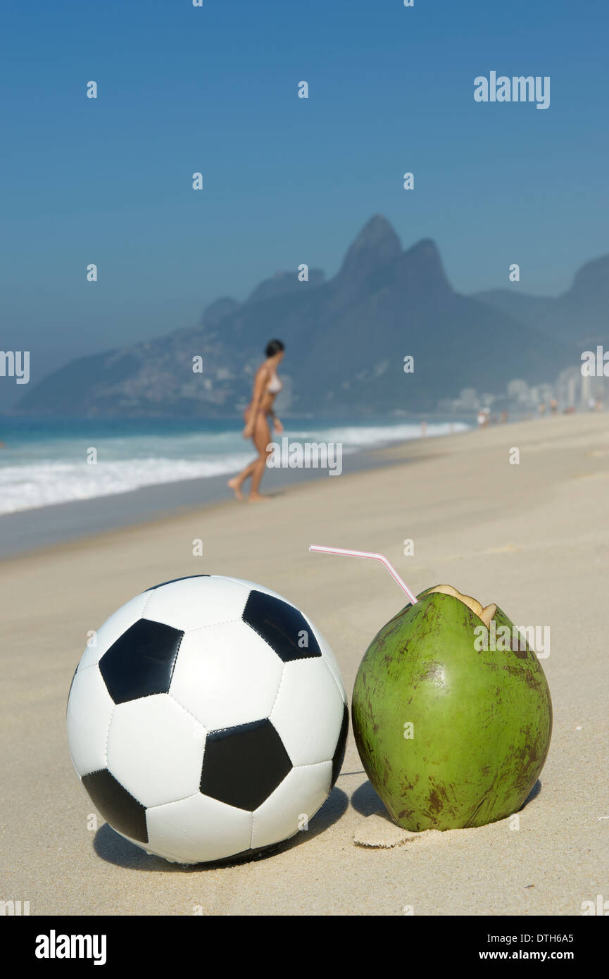 Fresh green drinking coconut coco gelado next to football soccer ball ...