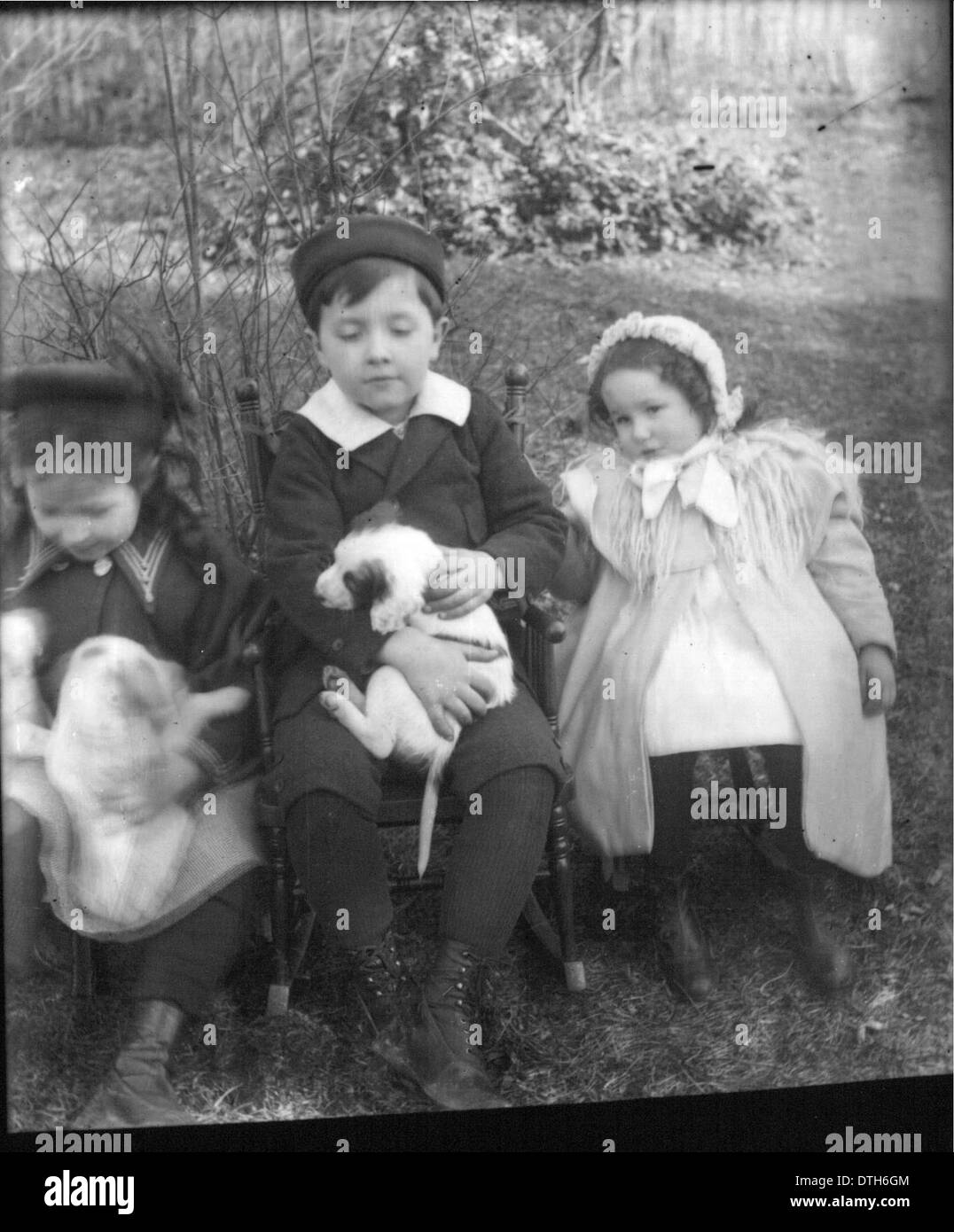 This photograph shows a group of children, a boy and girls, with ...