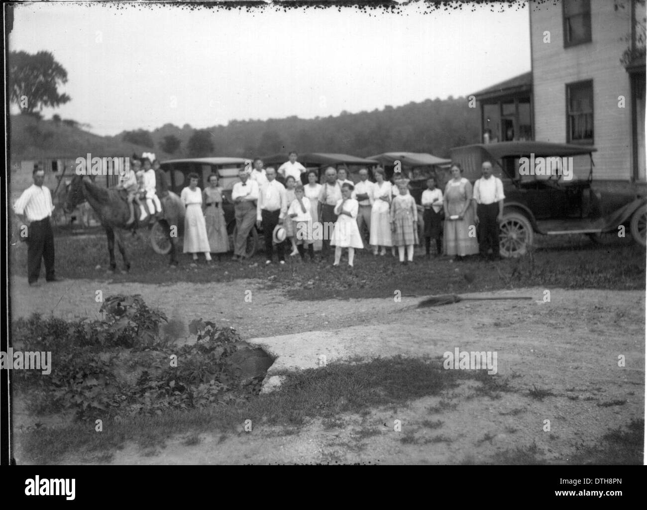 This vintage photograph captures a large group of people gathered in a ...