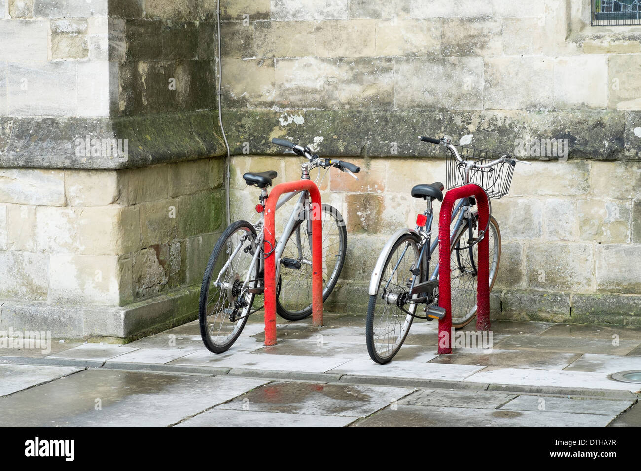 Two bicycles securely locked to metal posts in cycle parking area Stock ...