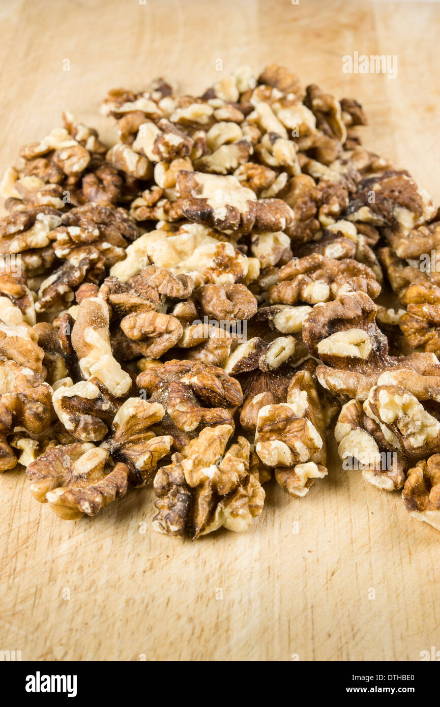 Close up photograph of shelled walnuts on a wooden chopping board Stock ...