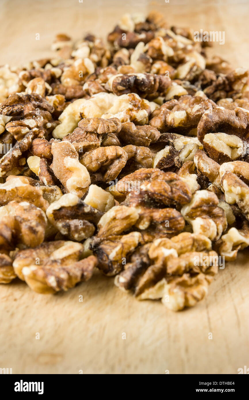 Close up photograph of shelled walnuts on a wooden chopping board Stock ...