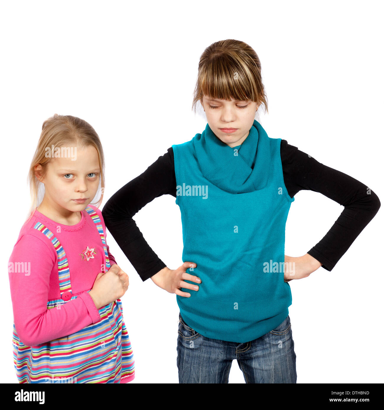 two very serious sisters on a white background Stock Photo - Alamy