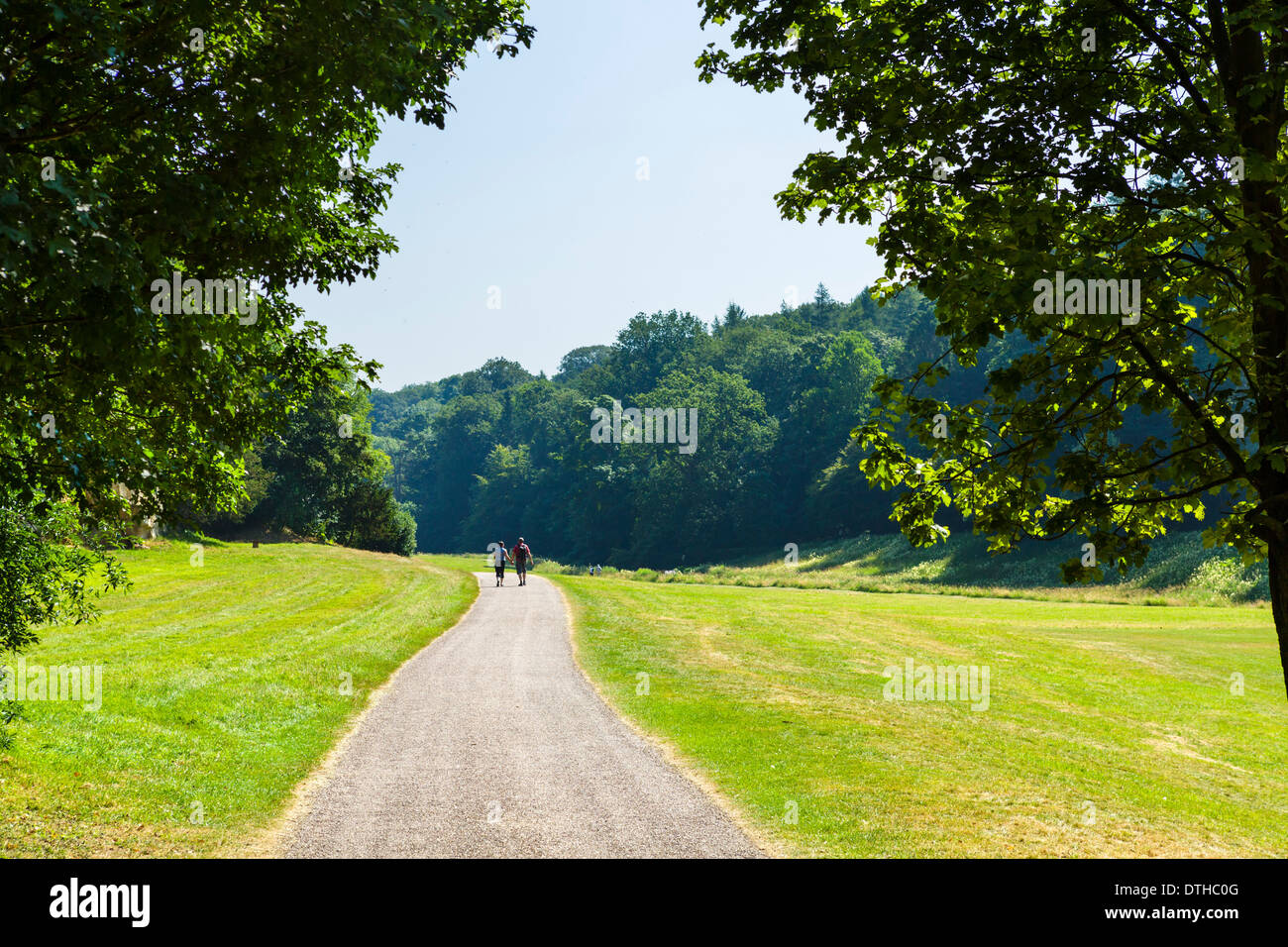 Couple walking along path at Fountains Abbey, near Ripon, North ...