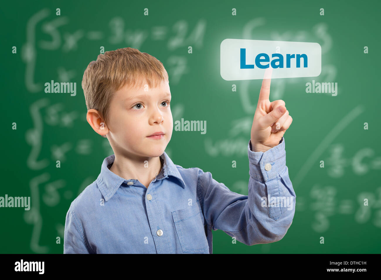 Child touching a button learn on a touchscreen Stock Photo - Alamy
