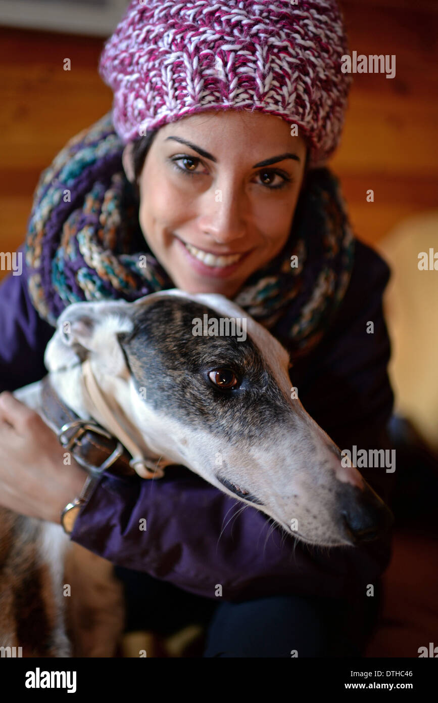 Young woman hugging her greyhound dog Stock Photo - Alamy
