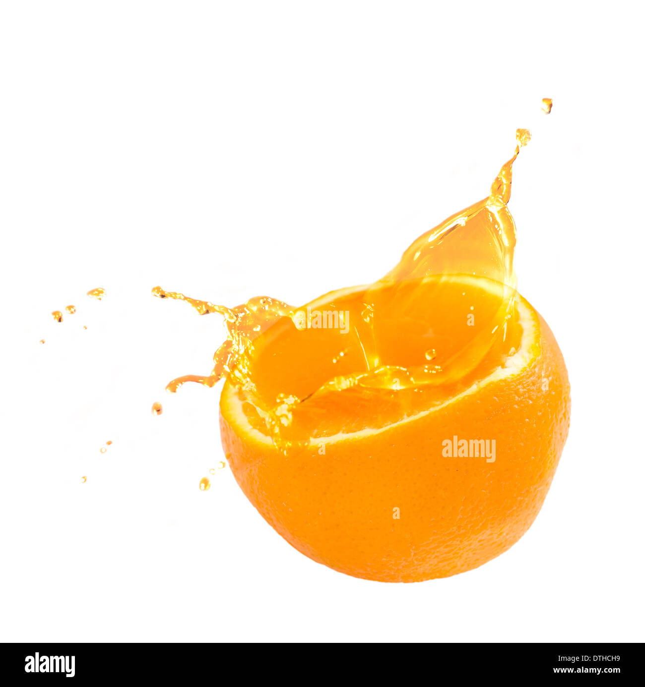 Orange juice splashing isolated on white background Stock Photo - Alamy