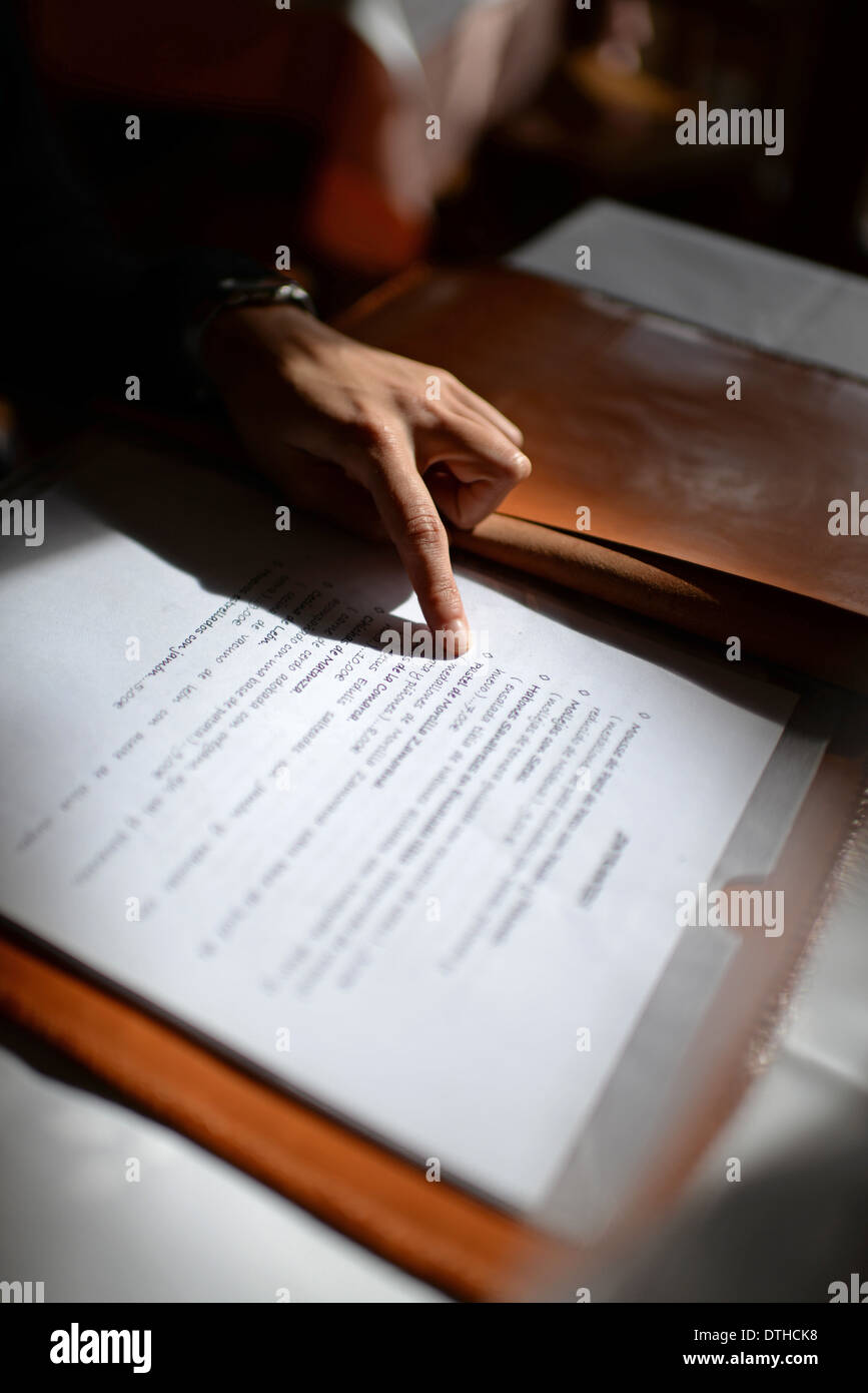 Young woman reading restaurant menu Stock Photo - Alamy