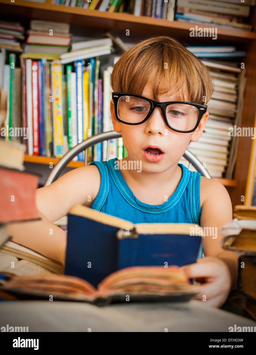 boy reading book while preparing for lesson Stock Photo - Alamy