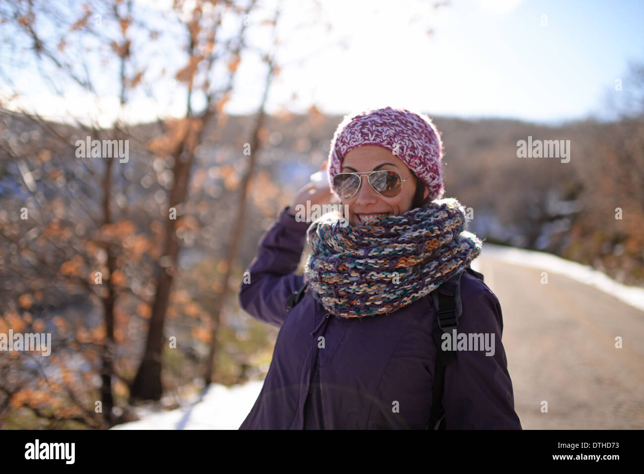 Young woman playing with snowballs in winter environment Stock Photo ...