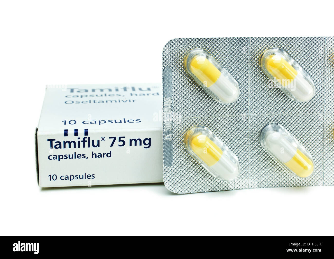 Yellow and white Tamiflu capsules in a blister pack next to a box of ...