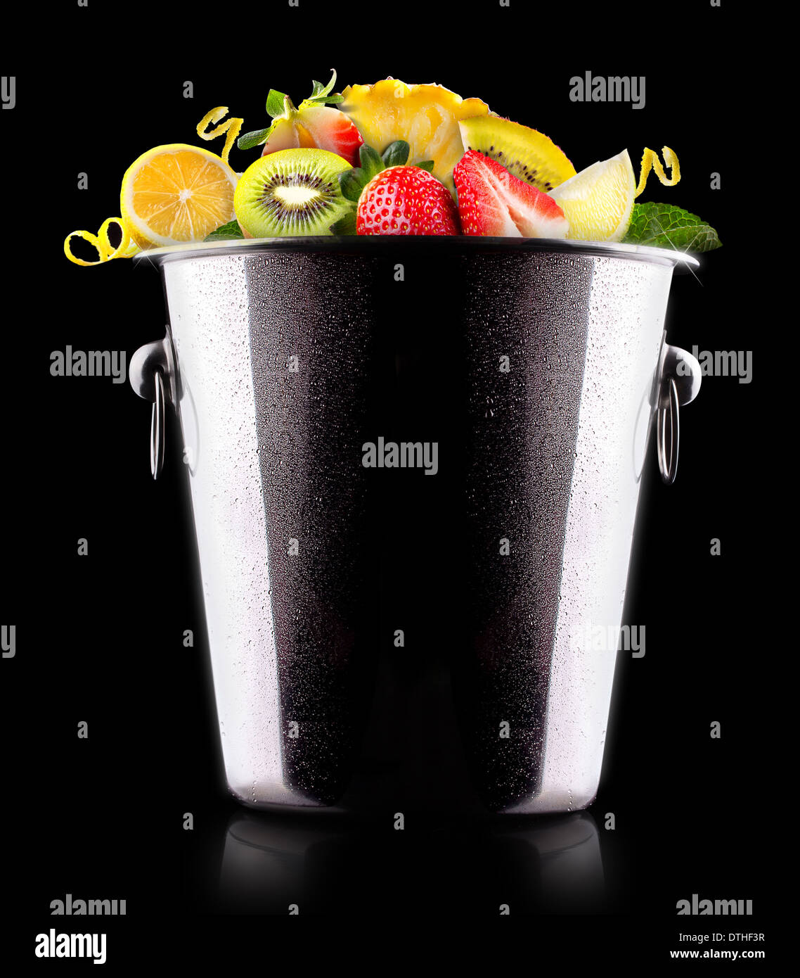 tasty summer fruits in bucket on a black background Stock Photo - Alamy