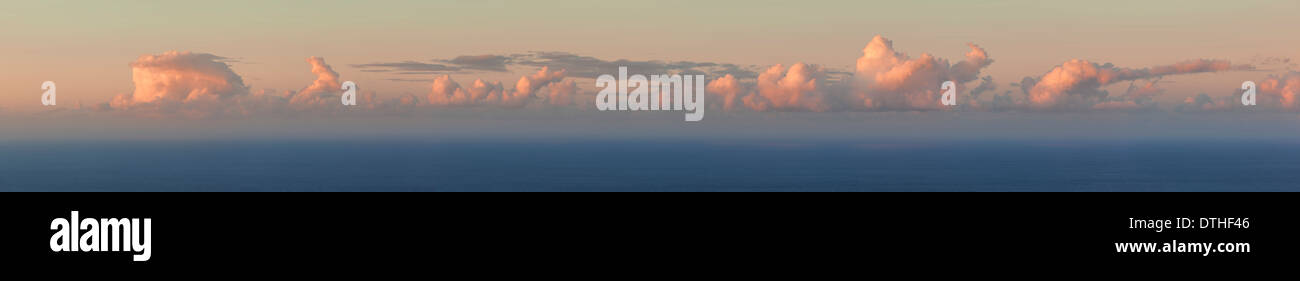 Cumulus cloud formation over the horizon at sunset. Wintertime. View ...