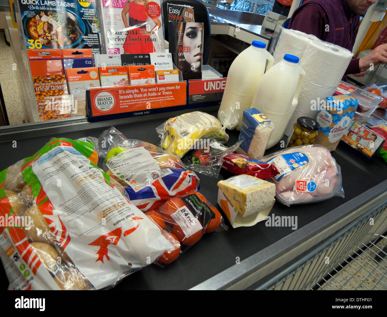 Groceries wrapped in plastic wrapping on the checkout counter of ...
