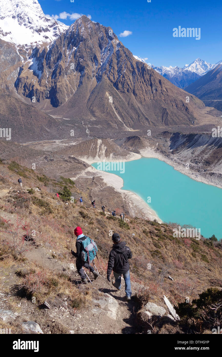 Hikers descending a trail above Birendra Tal (lake) in the Manaslu ...