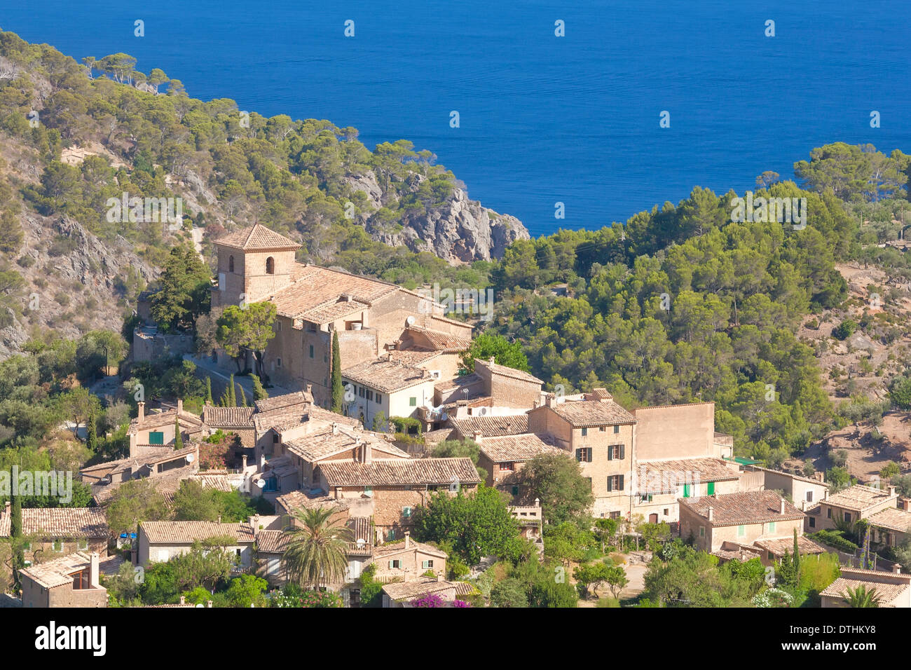 Deià village and church, northwest coast of Majorca on a Summer morning ...