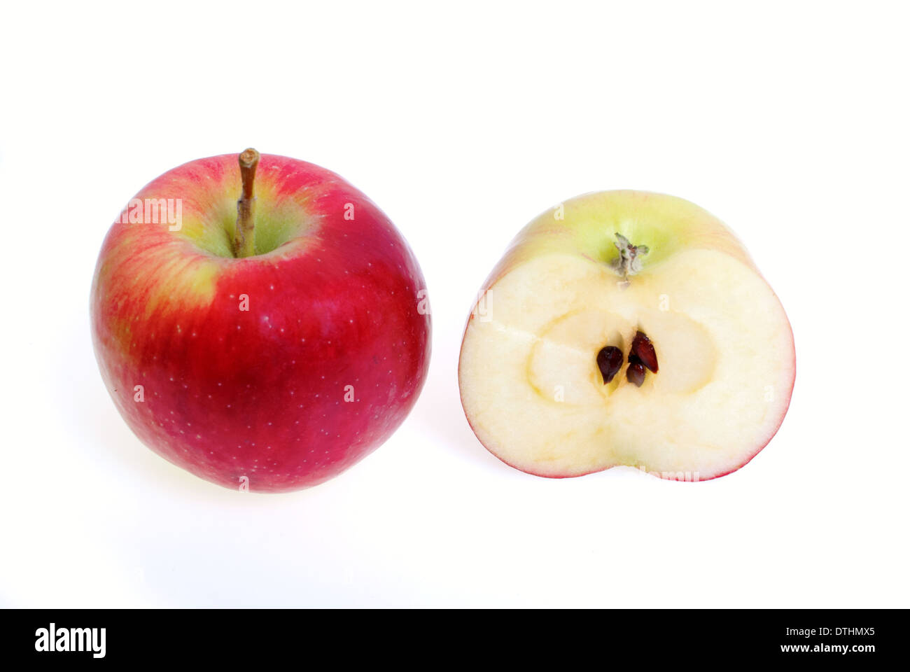 Two red apples - a whole one and another one cut in half, isolated on a ...