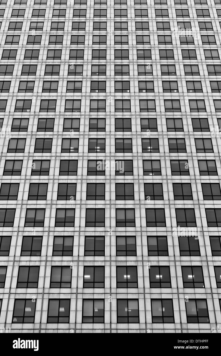 A black and white image of rows of glass windows of a modern office ...