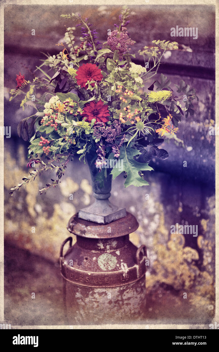 rustic flower arrangements on location in a walled garden Stock Photo ...