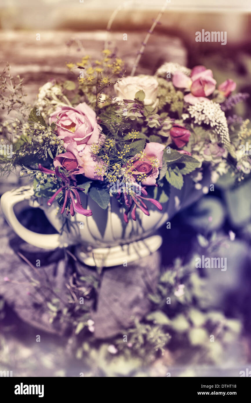 rustic flower arrangements on location in a walled garden Stock Photo ...