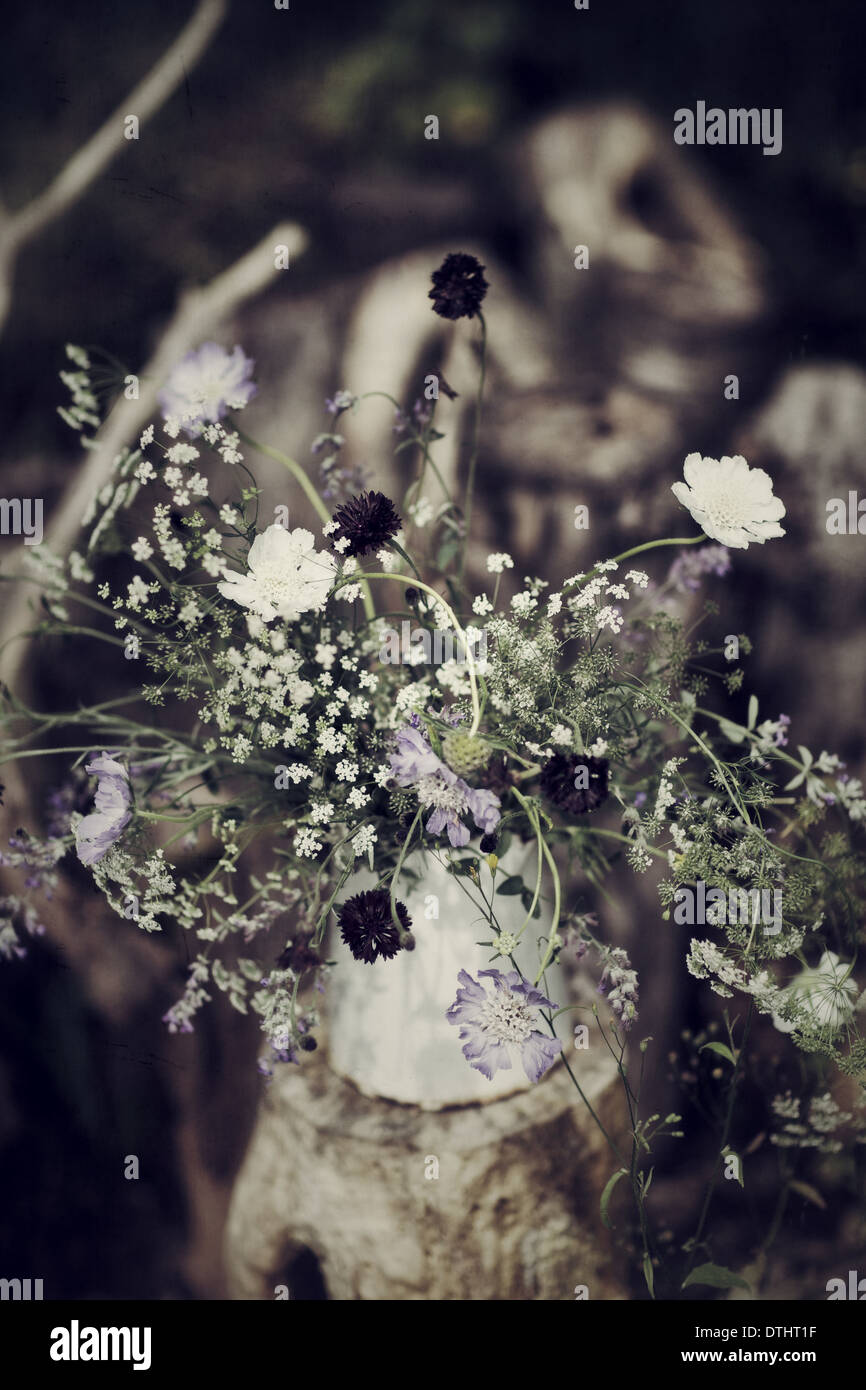 rustic flower arrangements on location in a walled garden Stock Photo ...