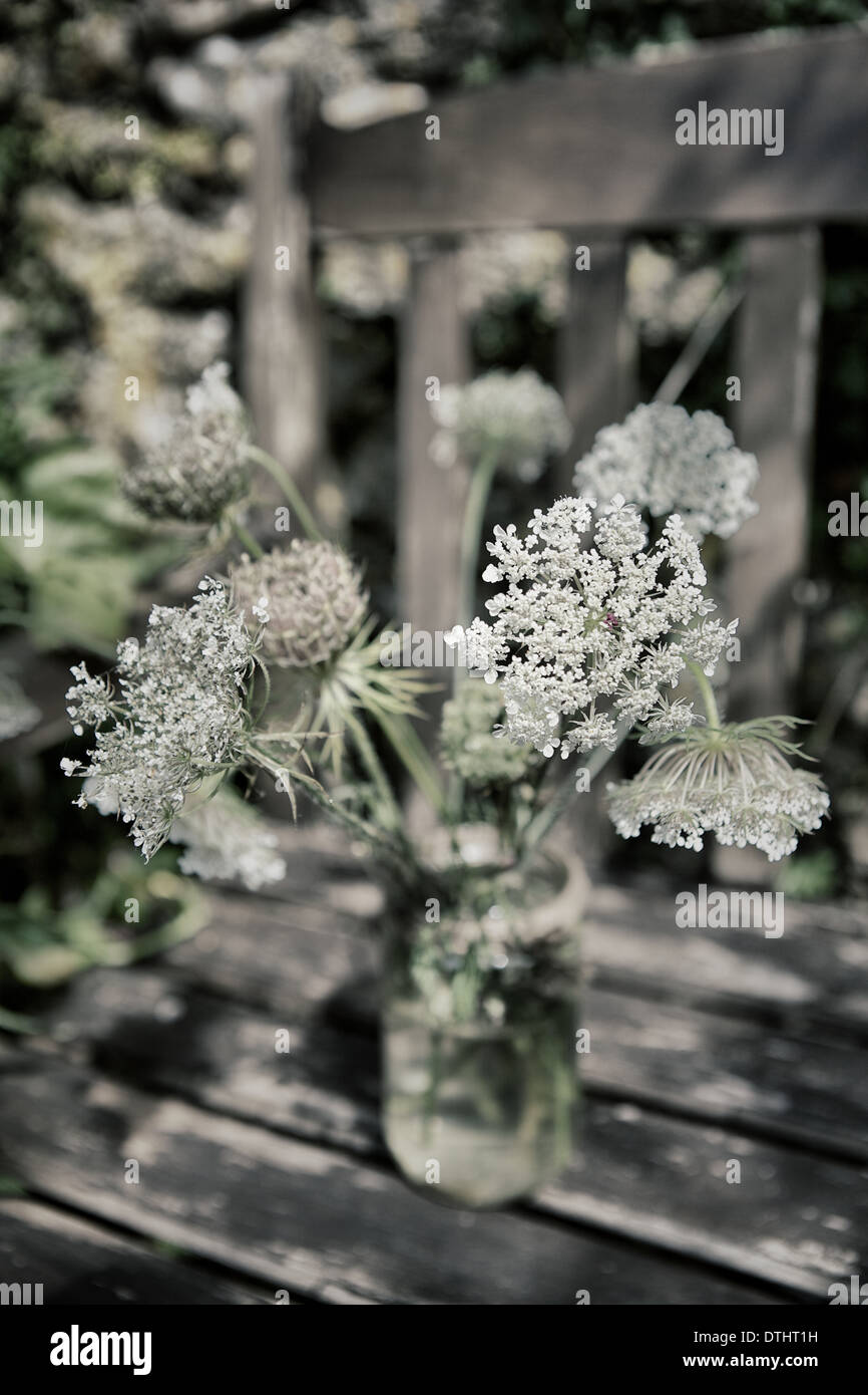 rustic flower arrangements on location in a walled garden Stock Photo ...