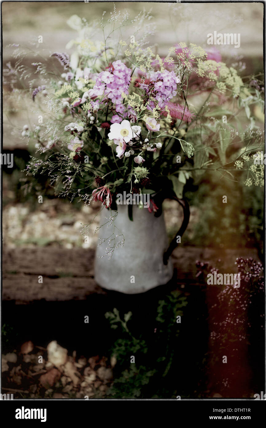 rustic flower arrangements on location in a walled garden Stock Photo ...