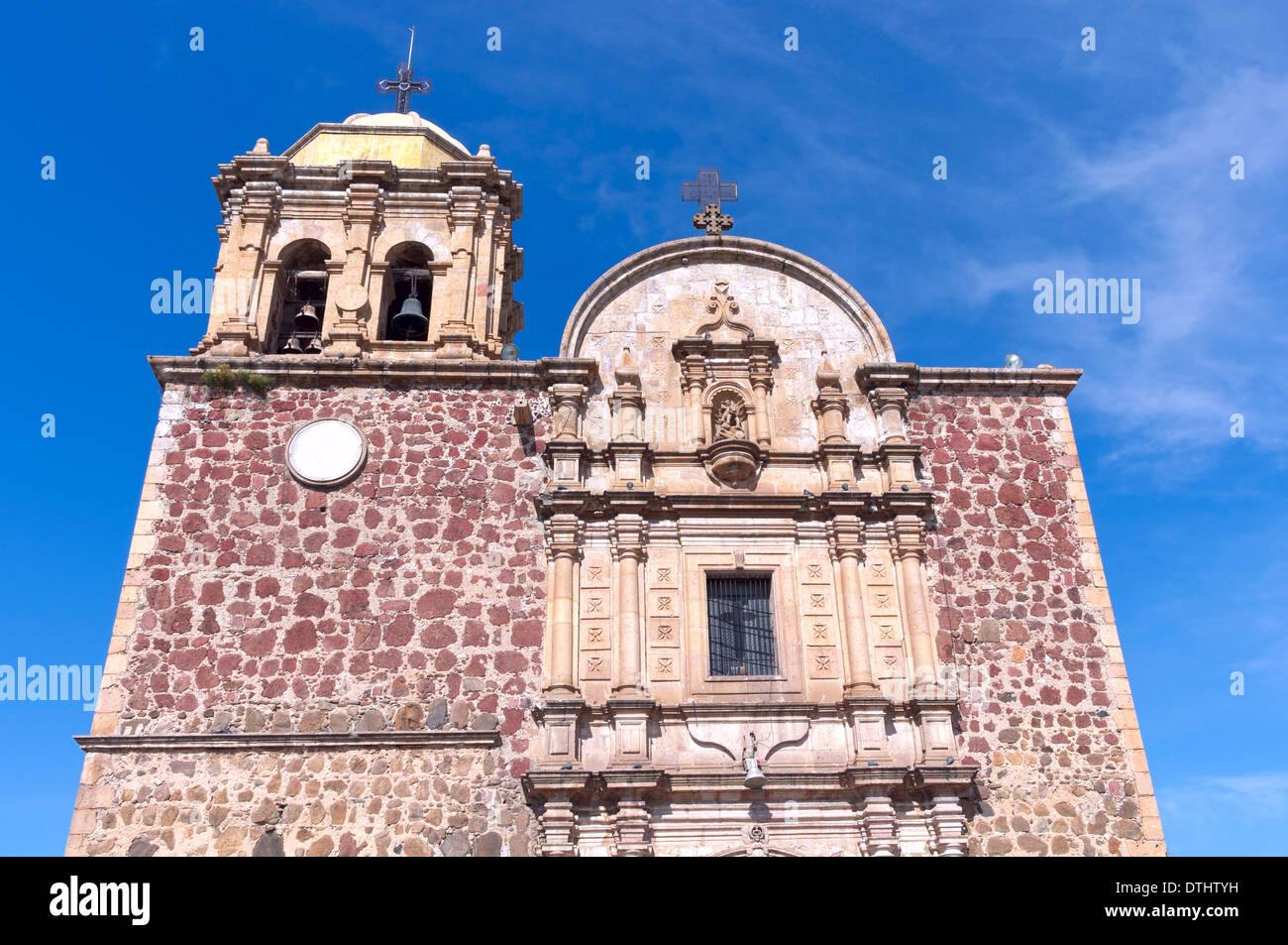 Church facade with columns arches and bell tower in Tequila Mexico ...