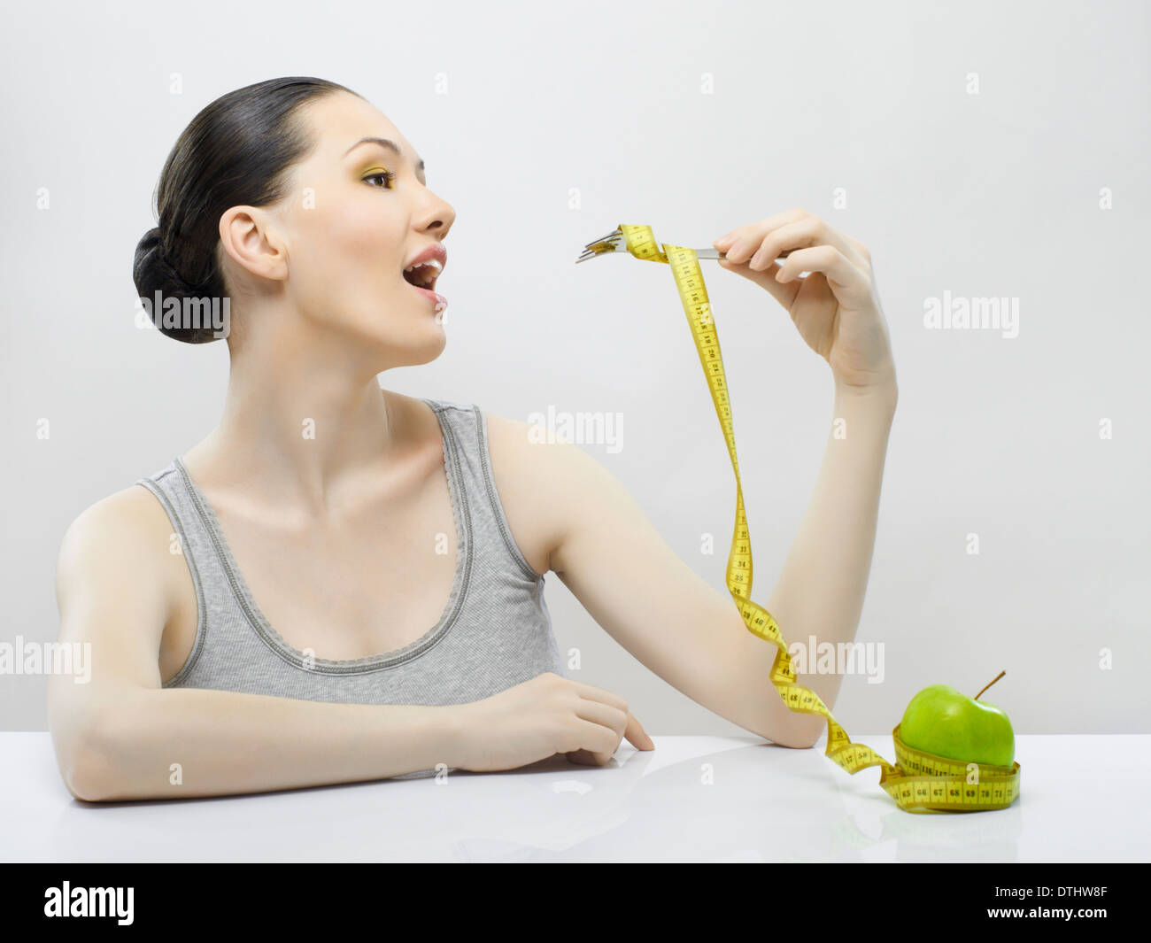 A beautiful slender girl eating healthy food Stock Photo - Alamy