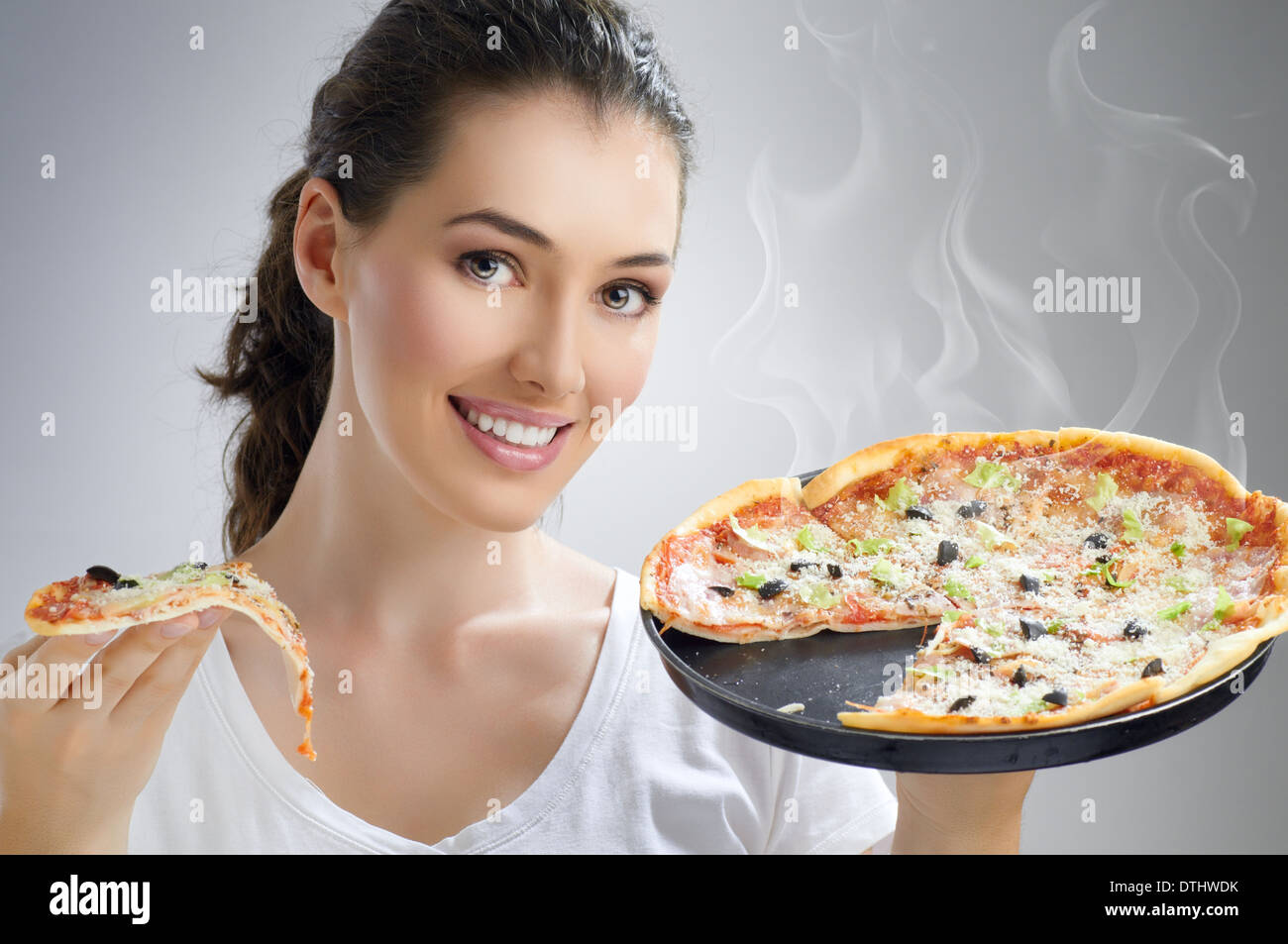 Girl eating a delicious pizza Stock Photo - Alamy