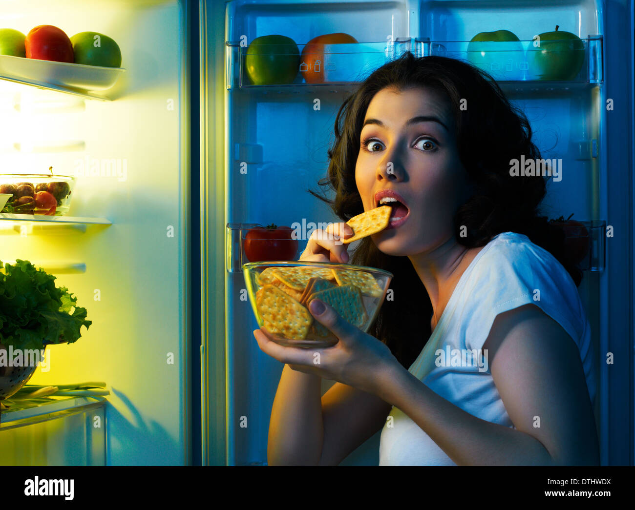 a hungry girl opens the fridge Stock Photo - Alamy