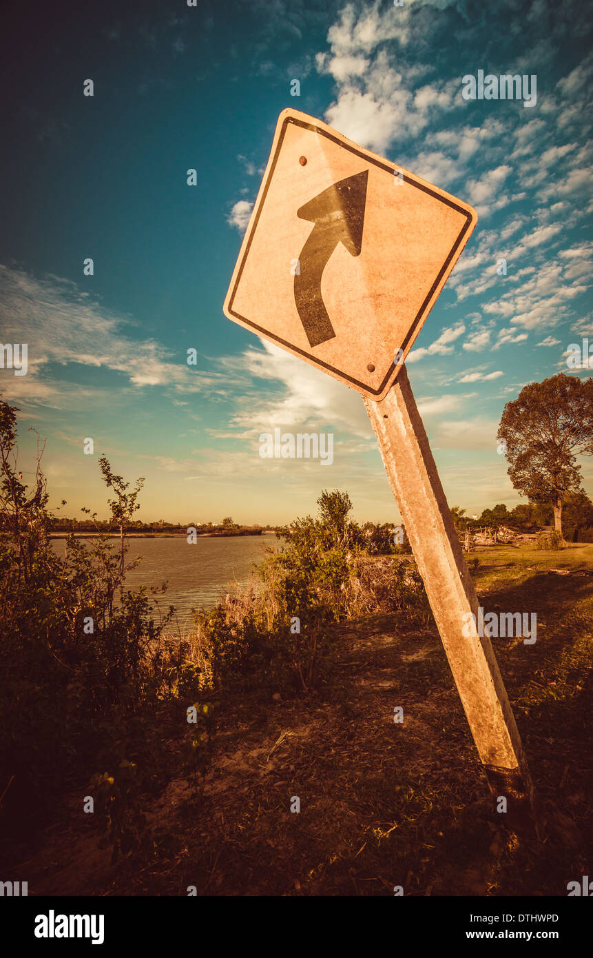 Turn left symbol and sky in the countryside Stock Photo - Alamy