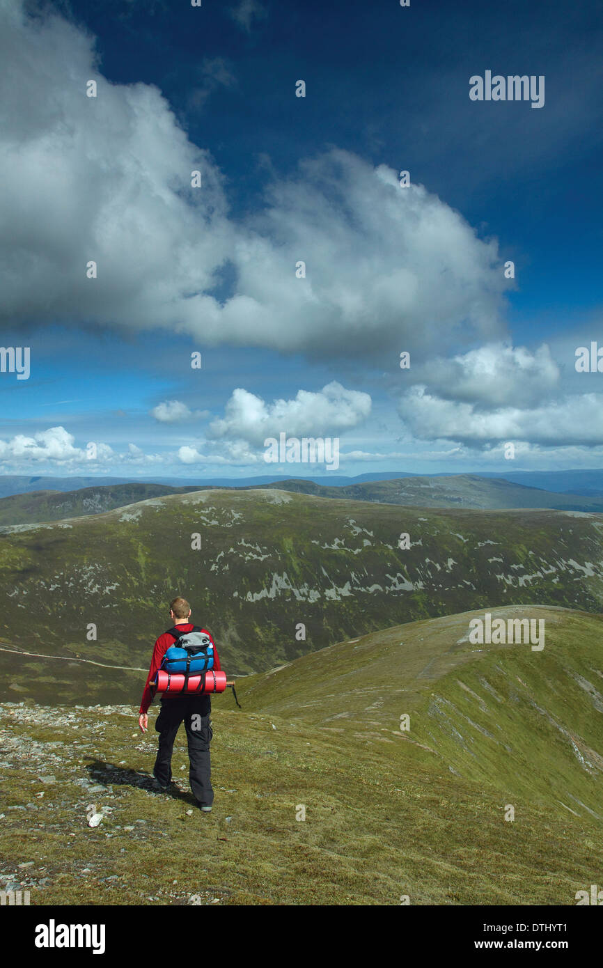 A walker descending the Munro of A'Mharconaich above the Drumochter ...