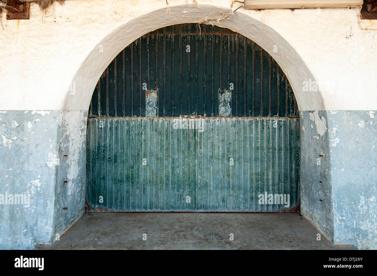 arched doorway with old metal doors Stock Photo - Alamy
