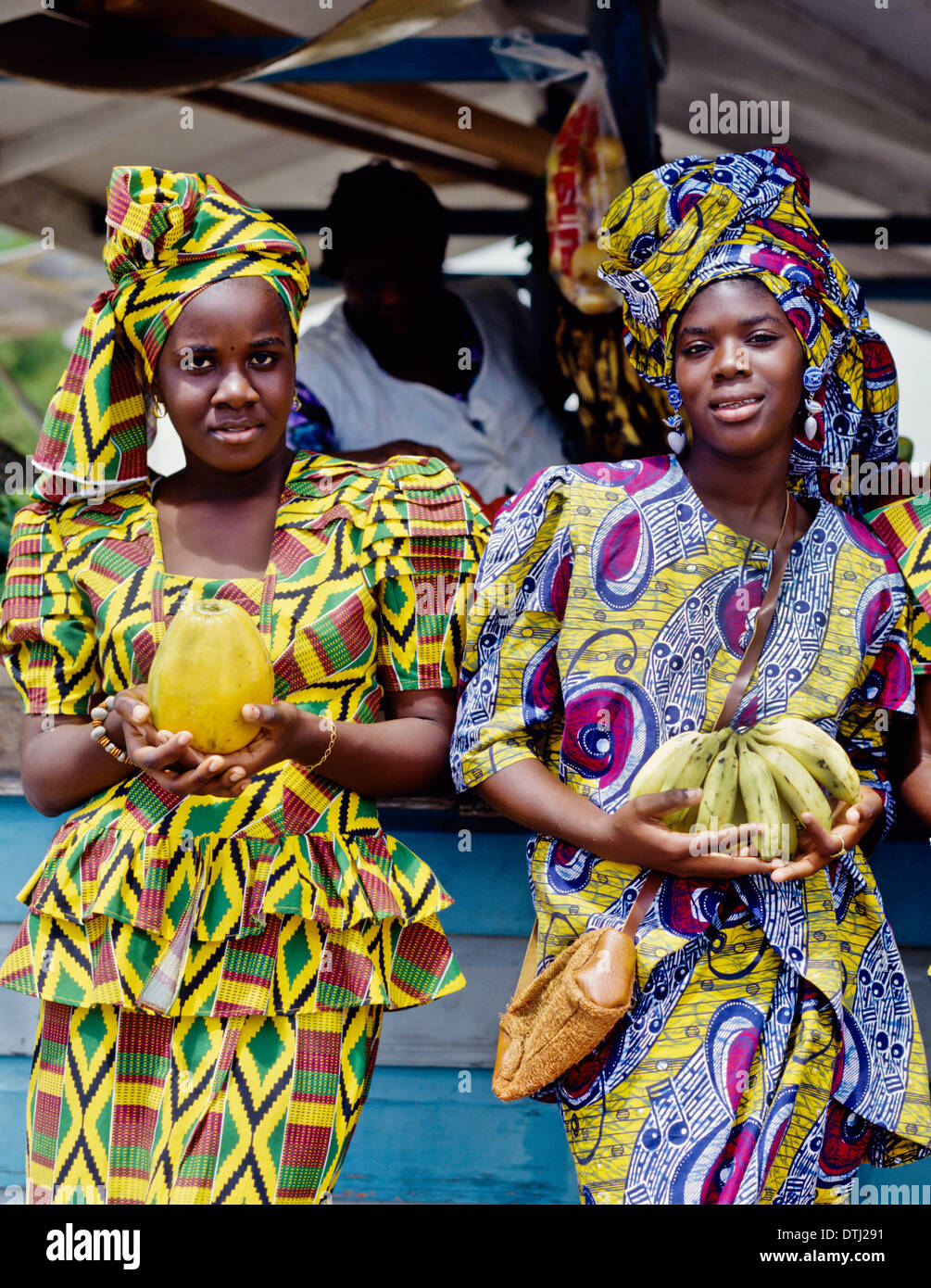 Local females in traditional attire holding fruits Stock Photo - Alamy